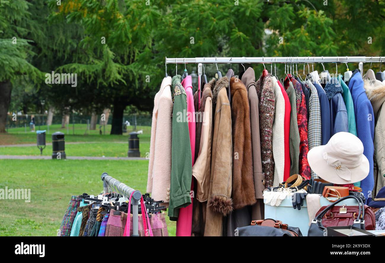 vintage used clothes and new dresses in the stall at the flea market ...