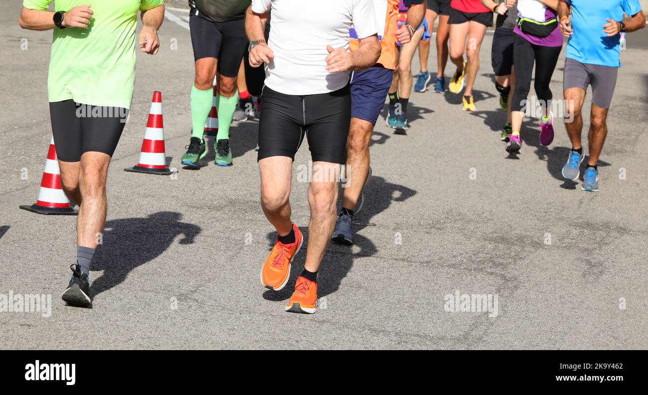 Athletic runners with muscular legs during the foot race in the city ...