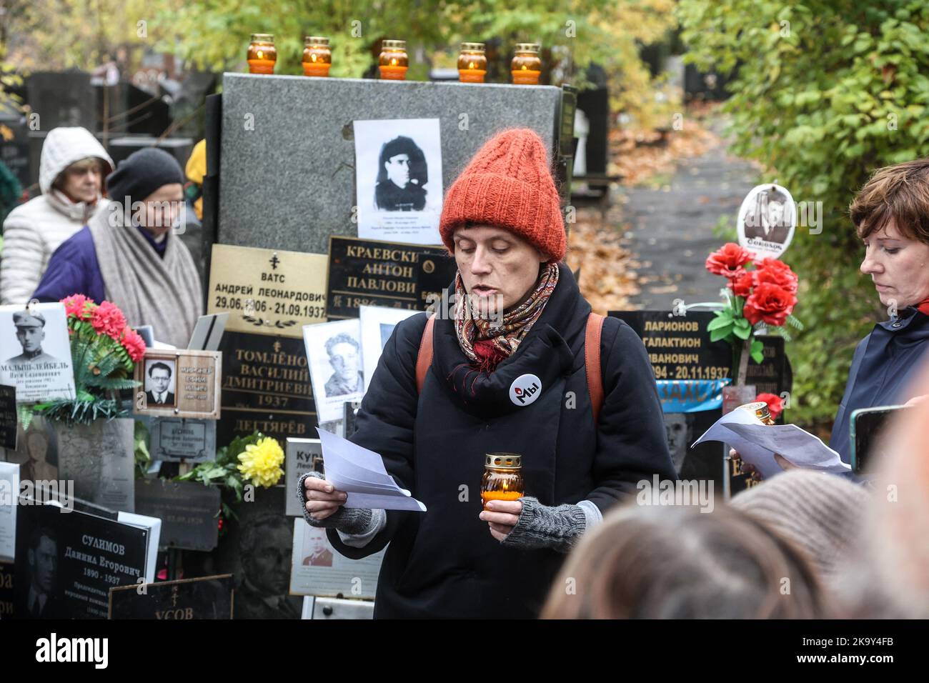 Woman reading the names of victims near the 'common grave no. 1' at the ...