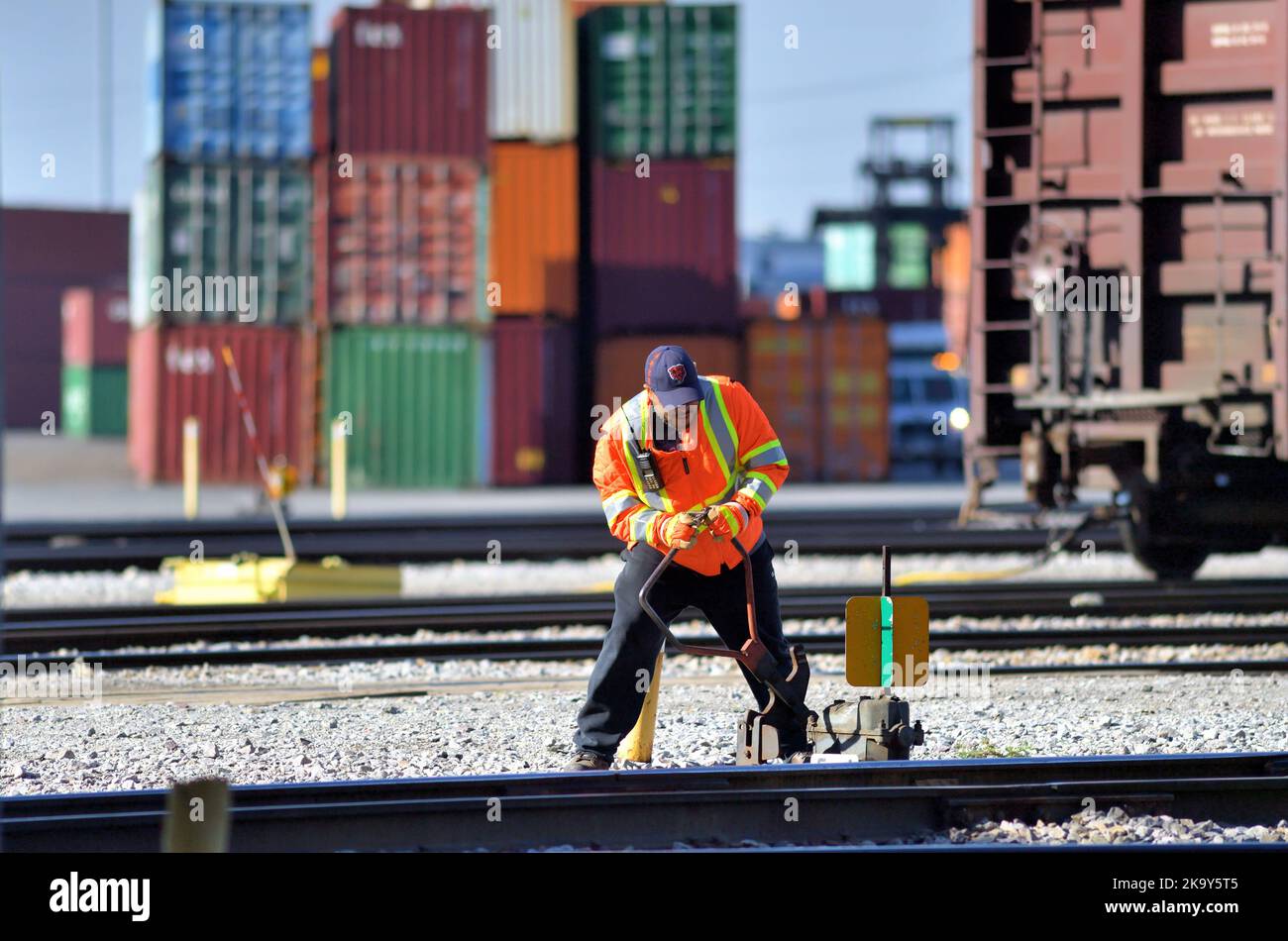 Franklin Park, Illinois, USA. A railroad worker manually throws a yard switch on a lead track to ...
