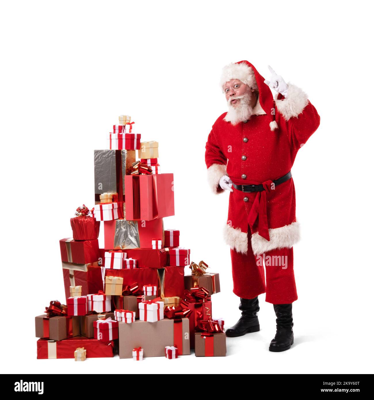 Santa Claus putting boxes into large pile of Christmas gifts isolated ...