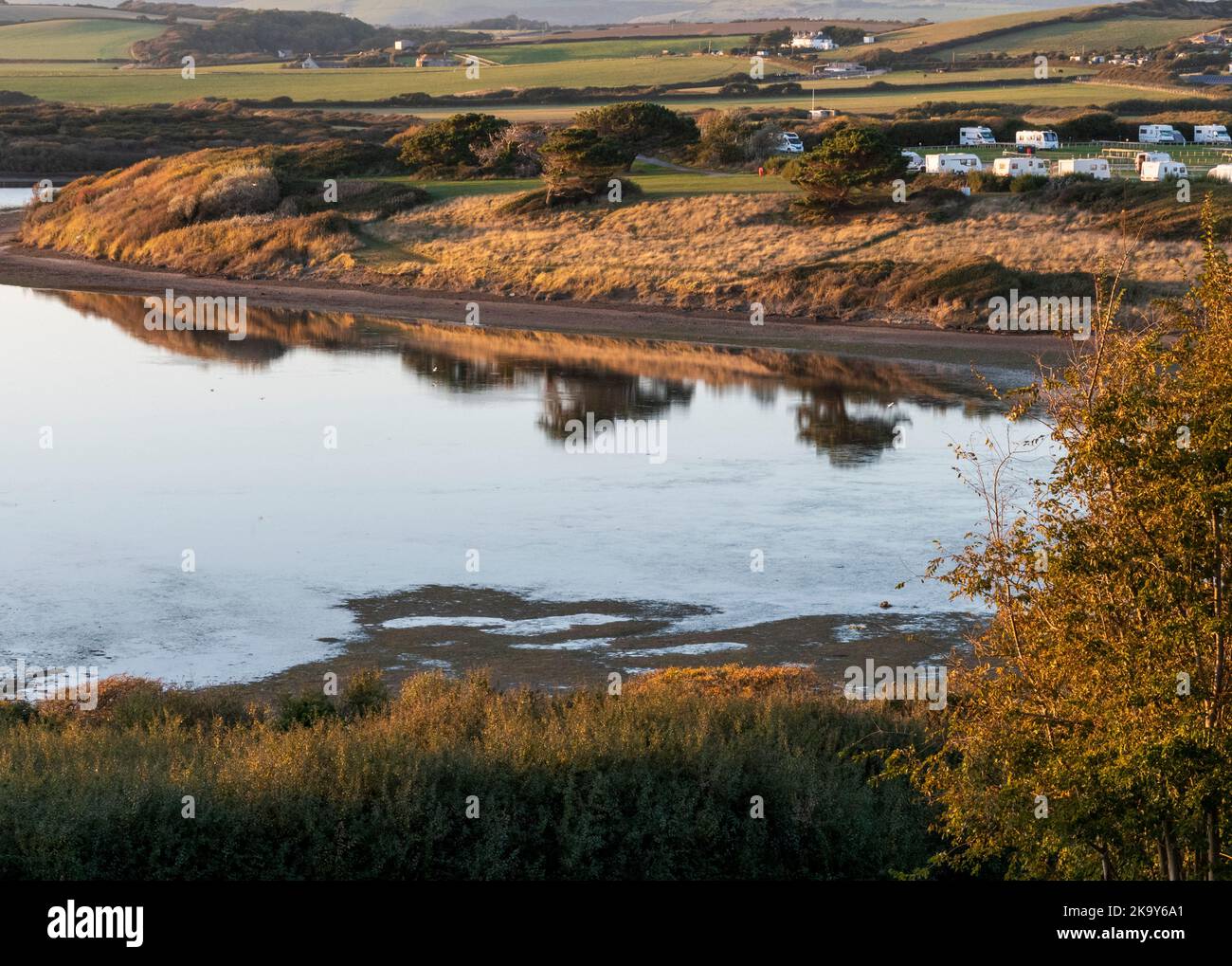 The Fleet lagoon, Weymouth, Dorset, UK as the sun is setting creating ...