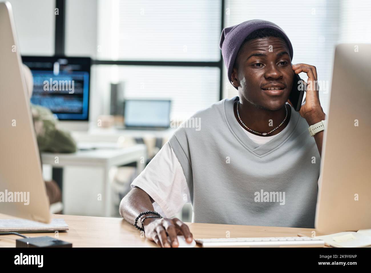 Young confident African American software developer consulting client ...