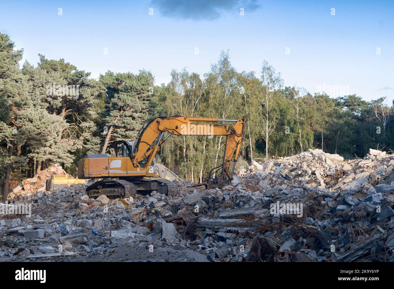 Process of demolition of old building dismantling. Excavator breaking ...