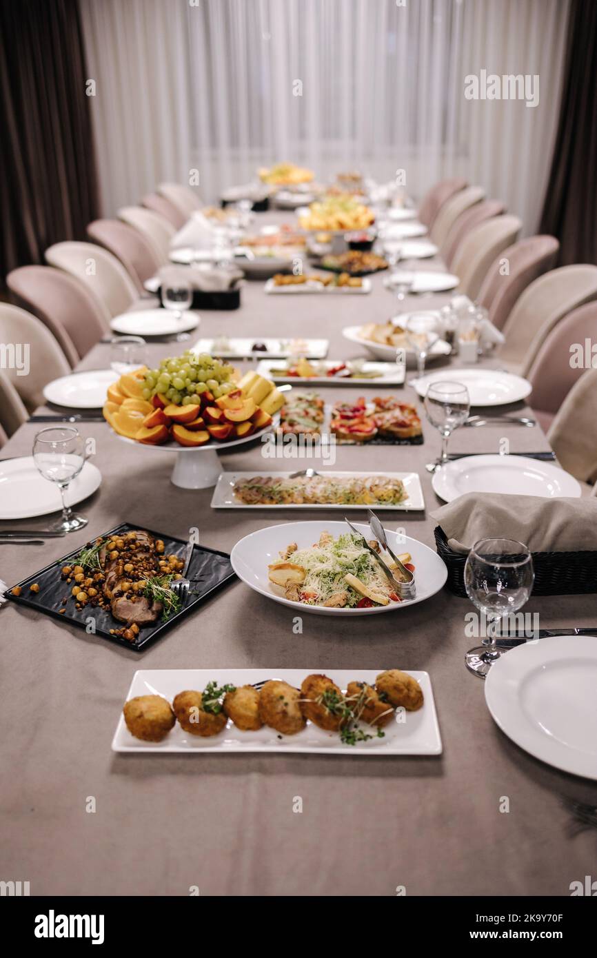 Table with different food and dishes. Celebration in restaurant Stock ...