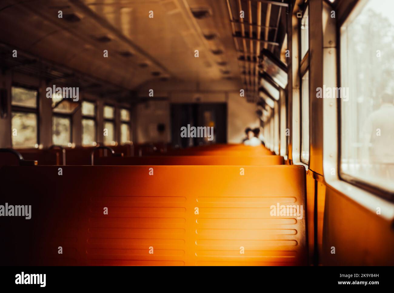 An empty carriage of an old commuter train with orange seats. Public ...