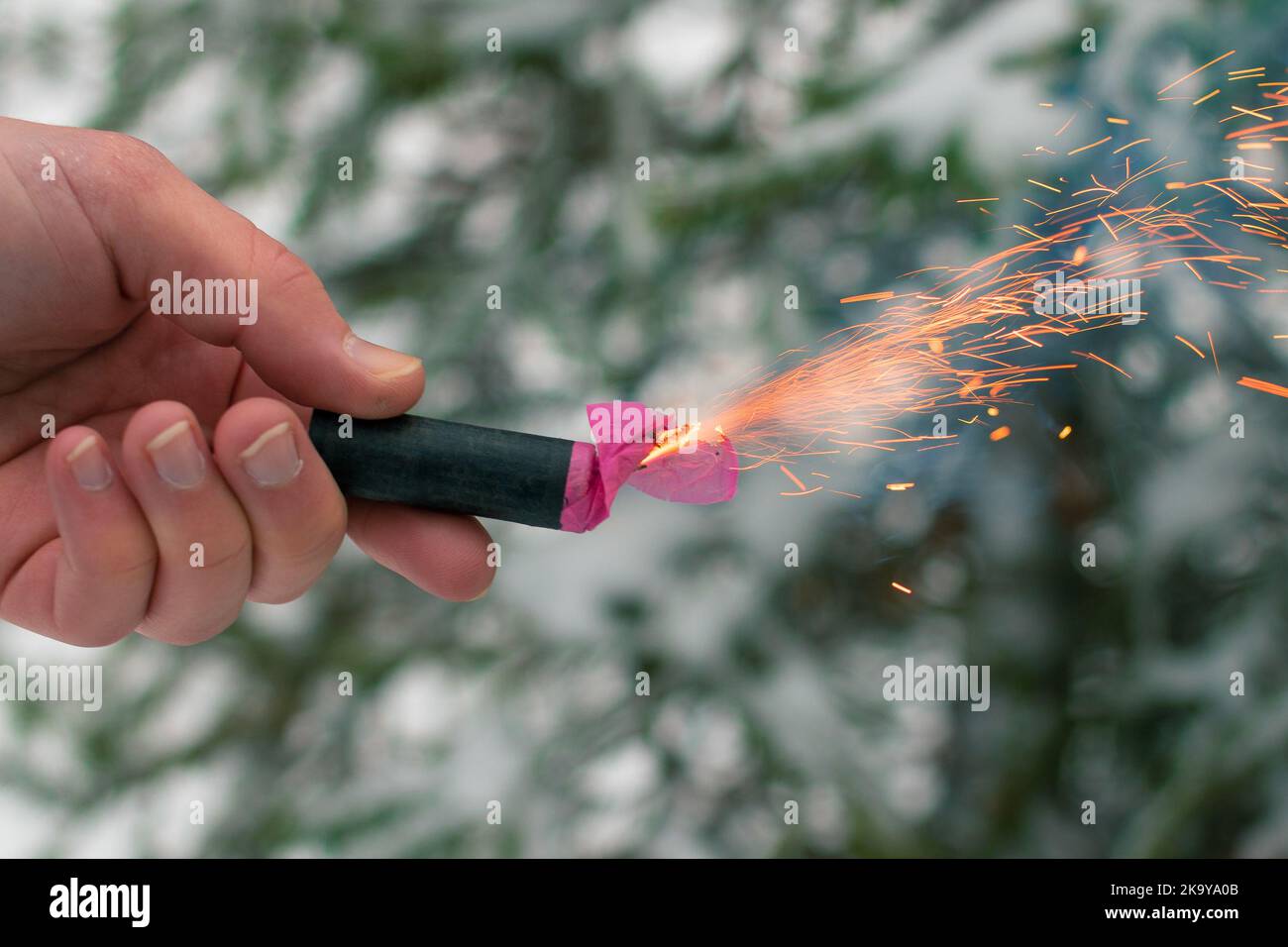 Burning Firecracker in a Hand. Guy Holding a Petard Outdoors in Winter ...