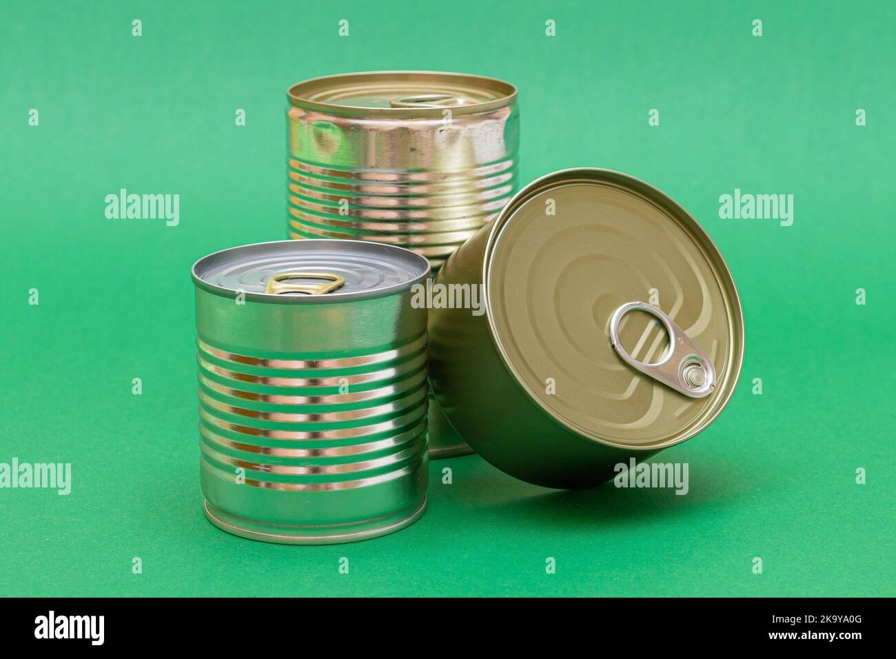 A Group of Stacked Tin Cans with Blank Edges on Green Background ...