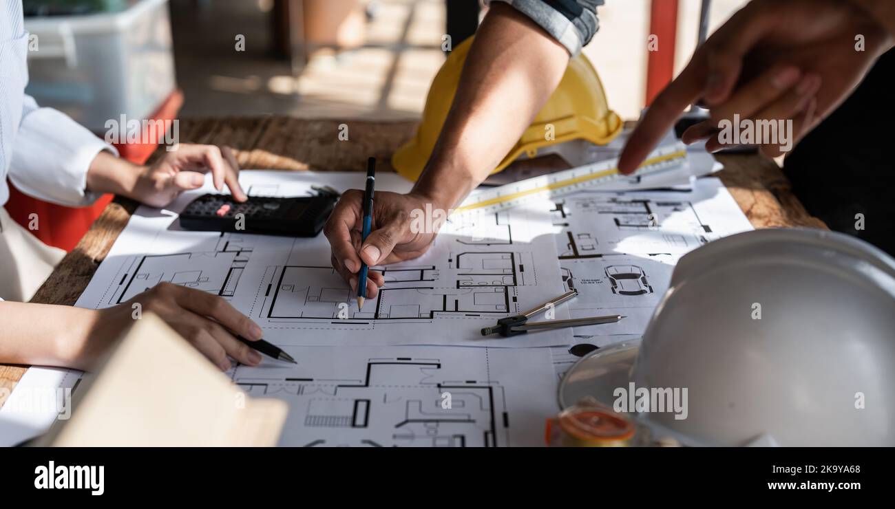Architect team working with blueprints for architectural plan, engineer ...