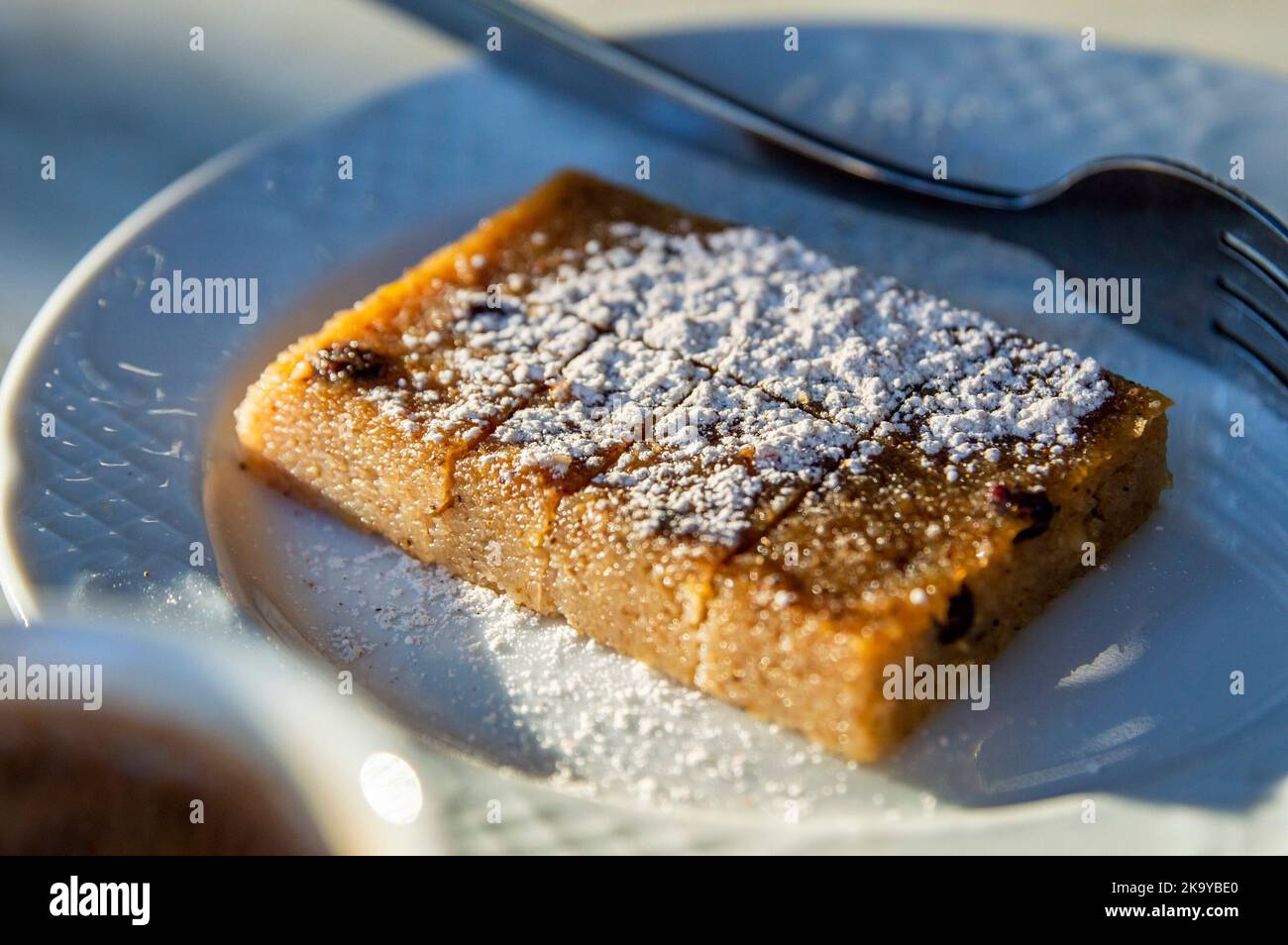 A slice of Greek cake under sunlight from a Greece local restaurant ...