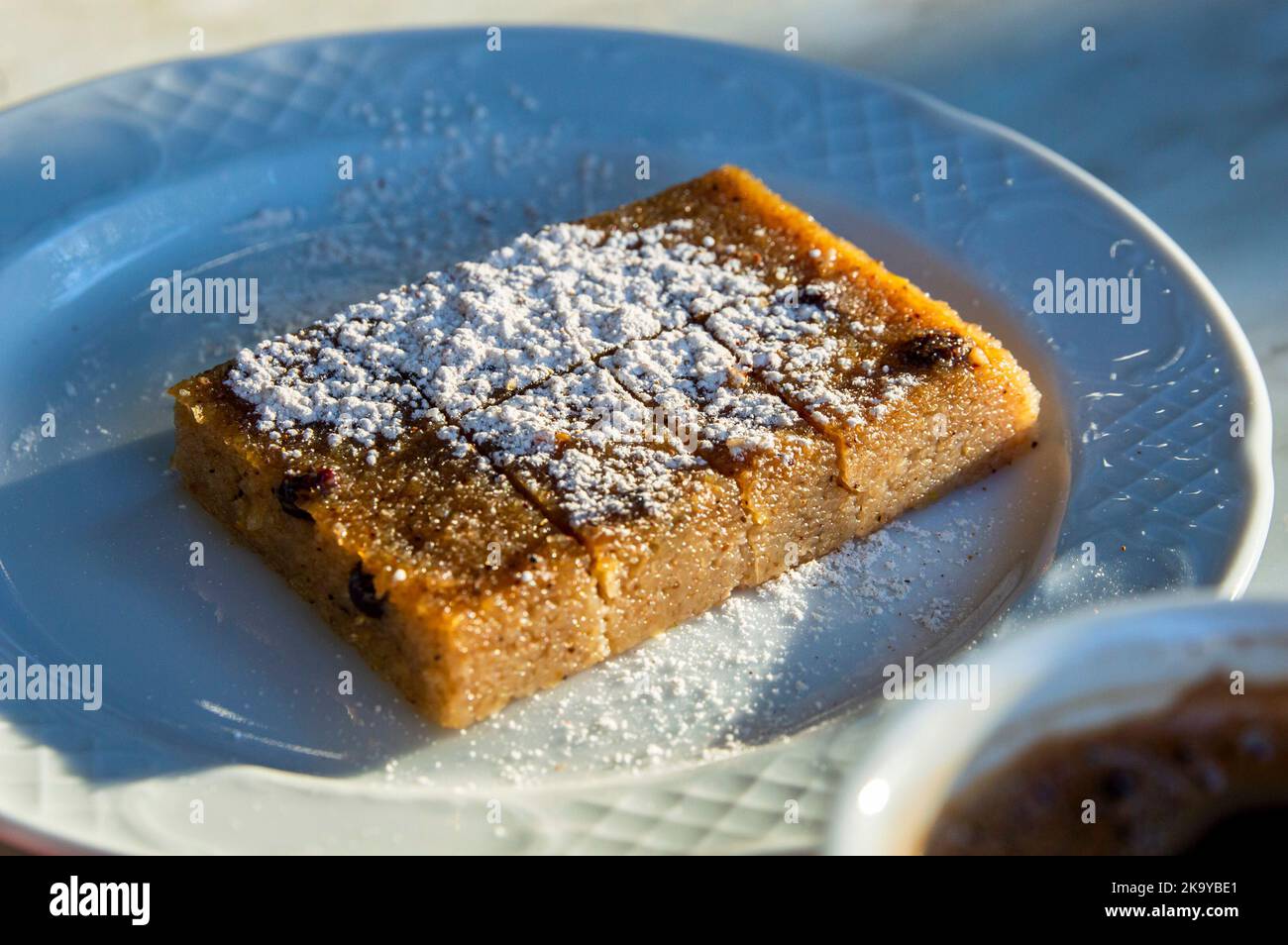 A slice of Greek cake under sunlight from a Greece local restaurant ...
