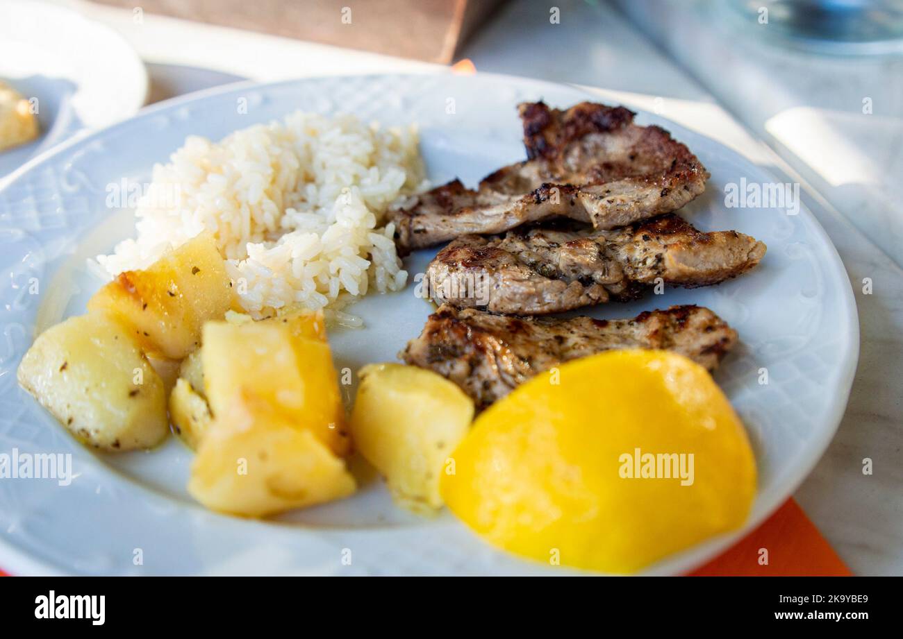 Greek grilled pork with rice and potatoes from a Greece local ...