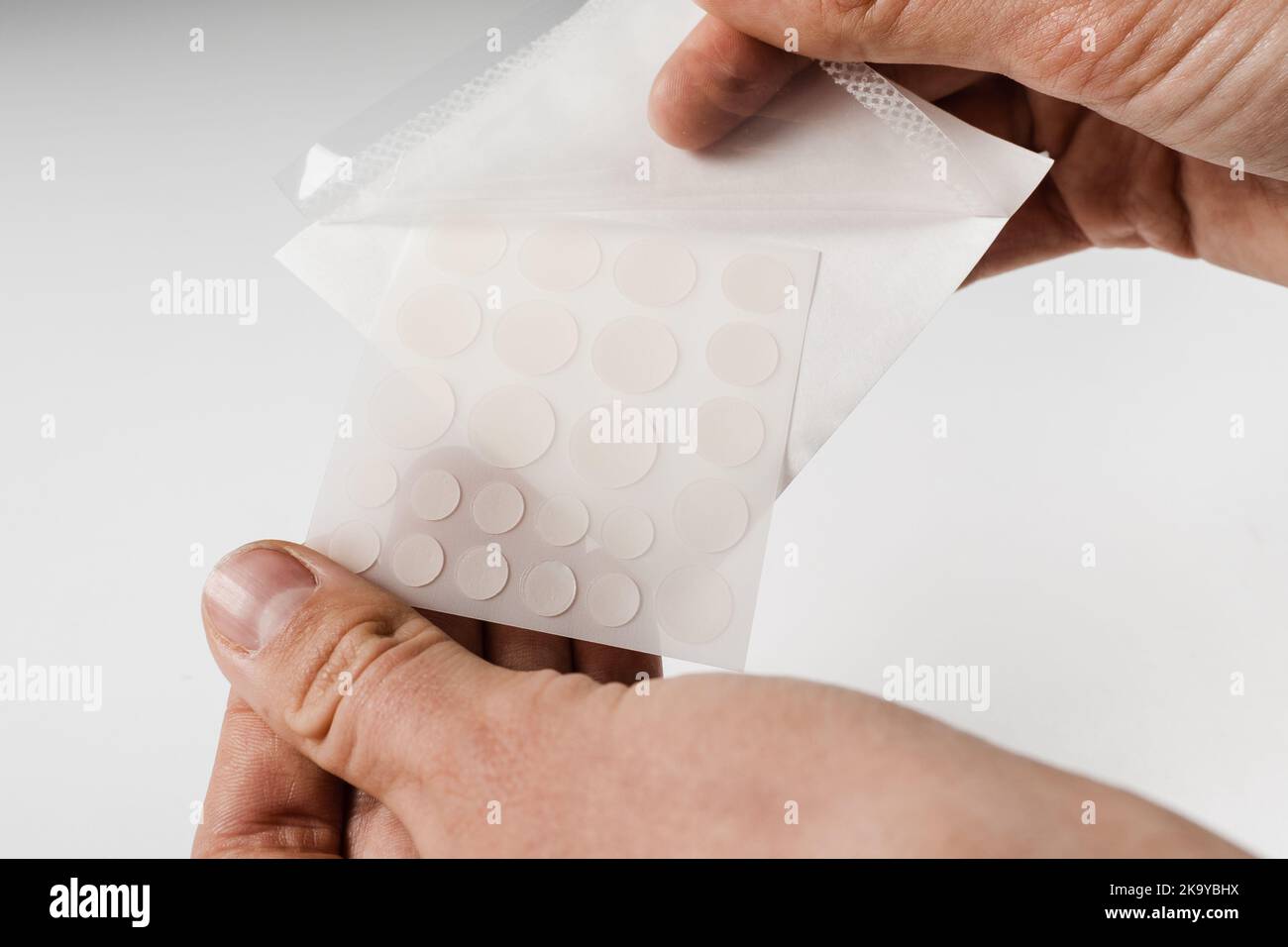 Acne patches for the treatment of pimple and rosacea close-up. Opening ...