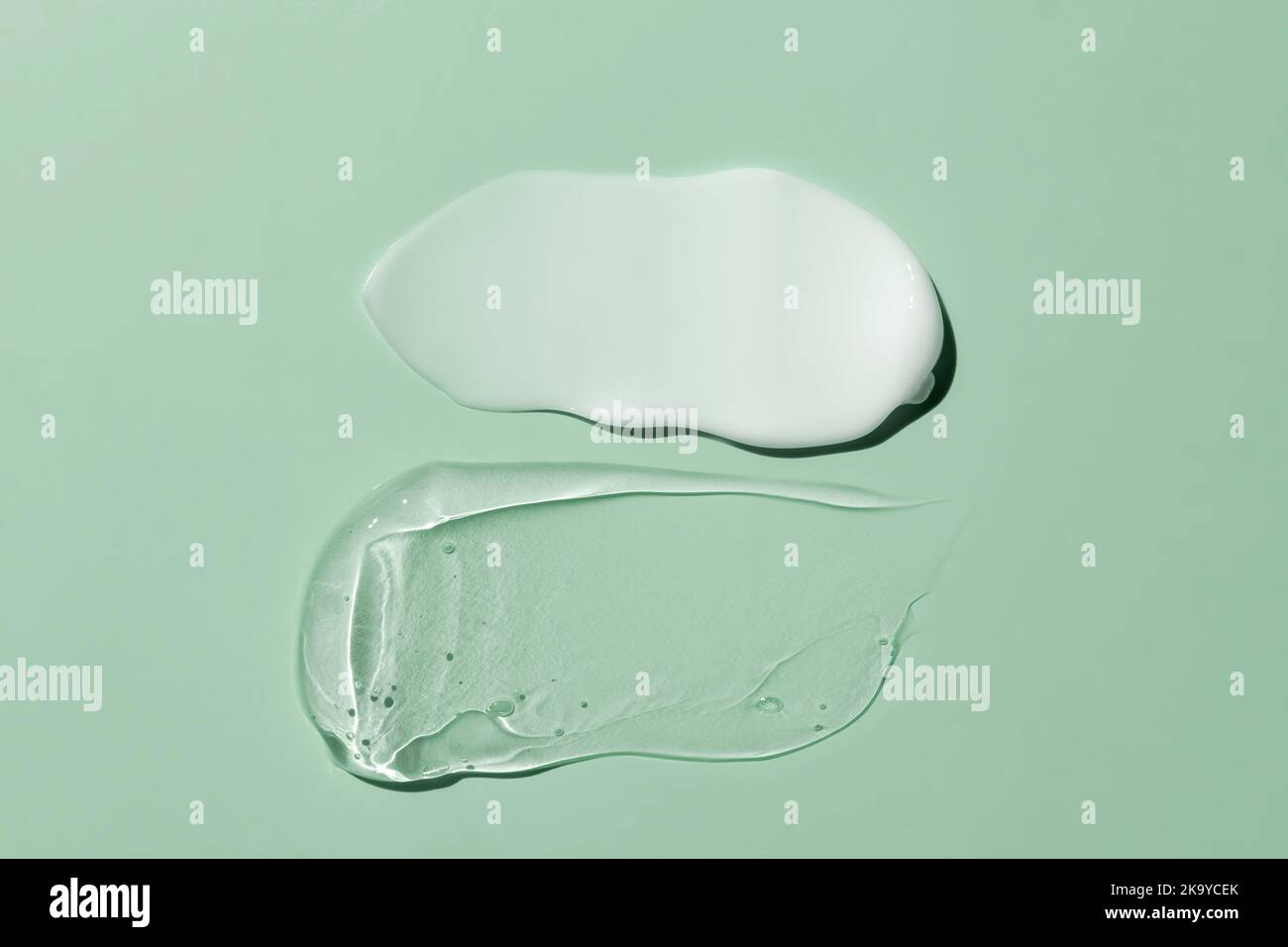 cosmetic smears cream texture on green background. Beauty serum drop ...