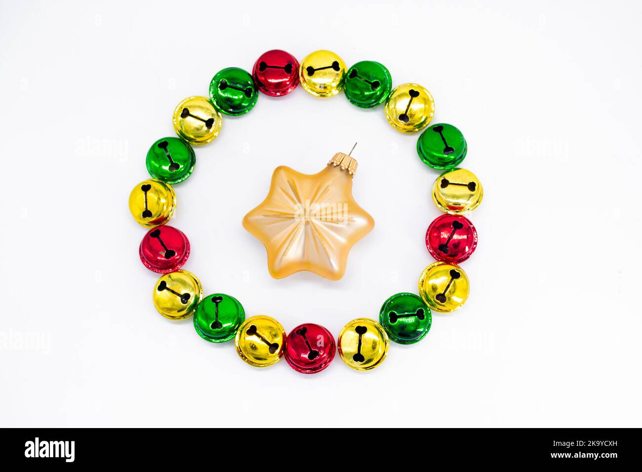 Colorful ringing Christmas bells in gold, red and green. In shape of ...