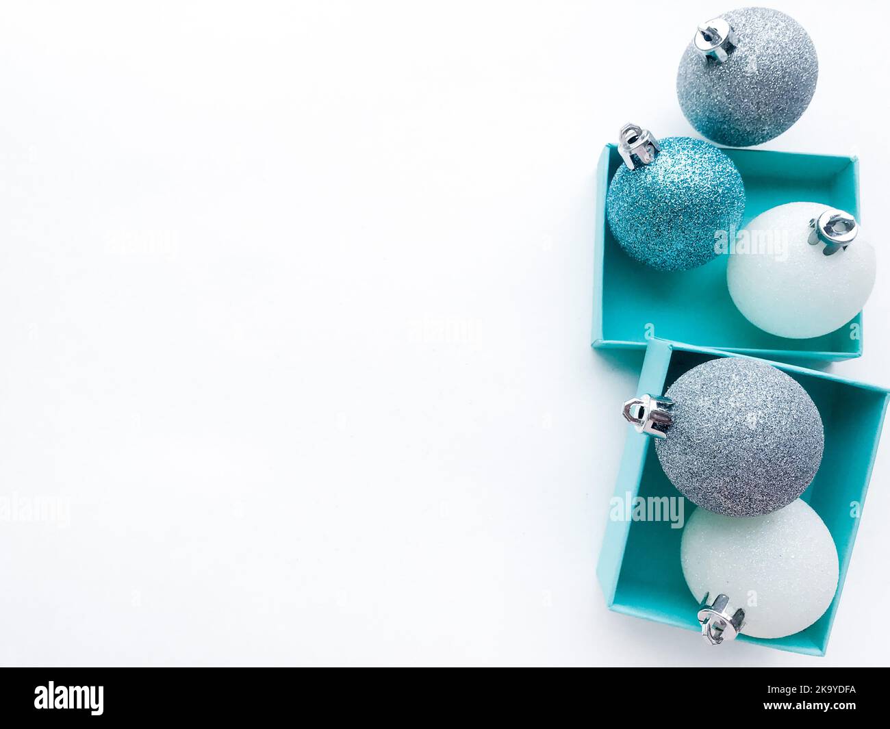 Turquoise jewel boxes inside of which is a shiny Christmas balls white ...