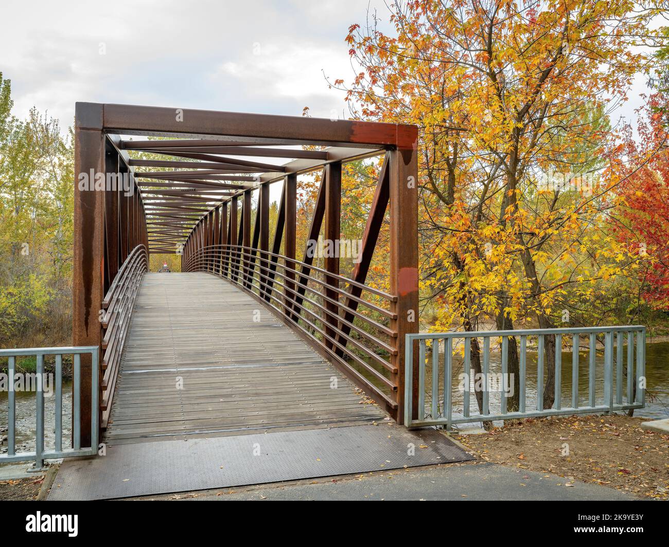 Autumn foliage abound around this foot bridge Stock Photo - Alamy