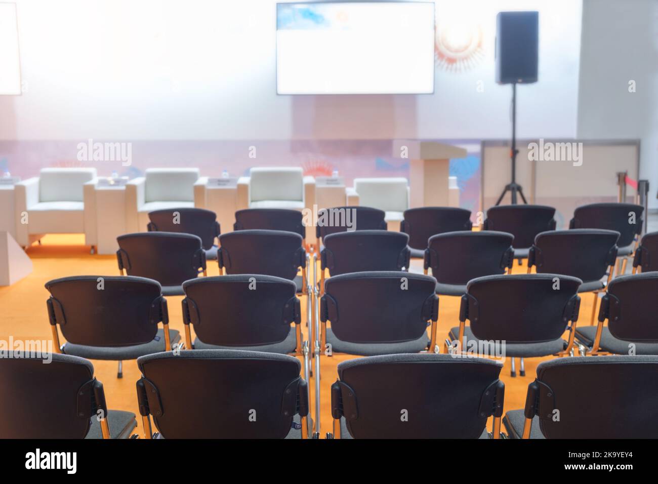 Super conference hall with black chairs and colored illumination and ...