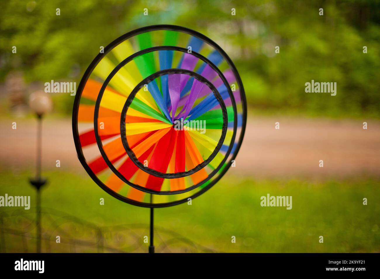 Colorful triple pinwheel spinning in the wind. Round pinwheel with ...