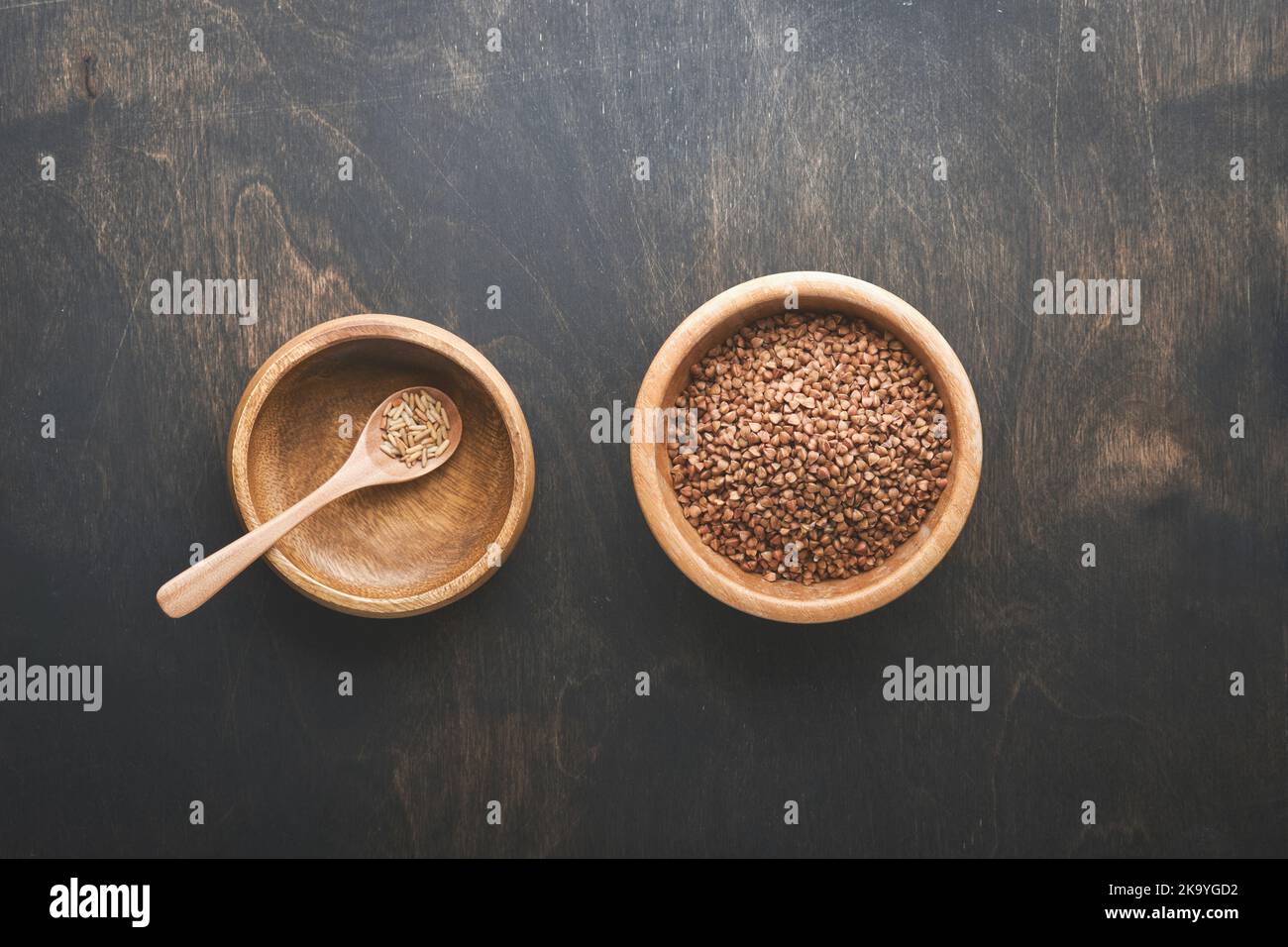 World food crisis concept. Empty and full old plate with buckwheat on a ...