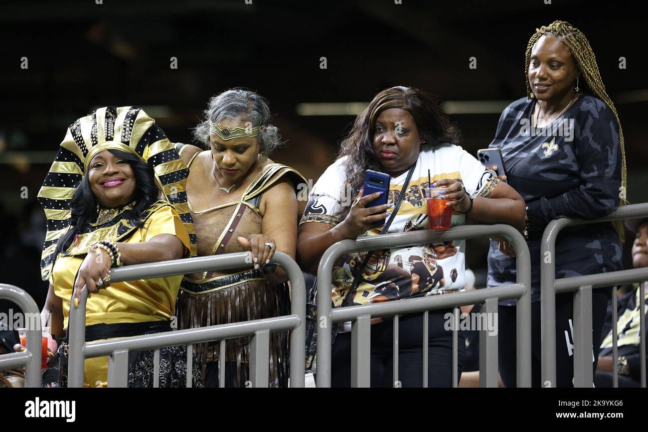 A quartet of New Orleans Saints fans all pose for a photo during a ...