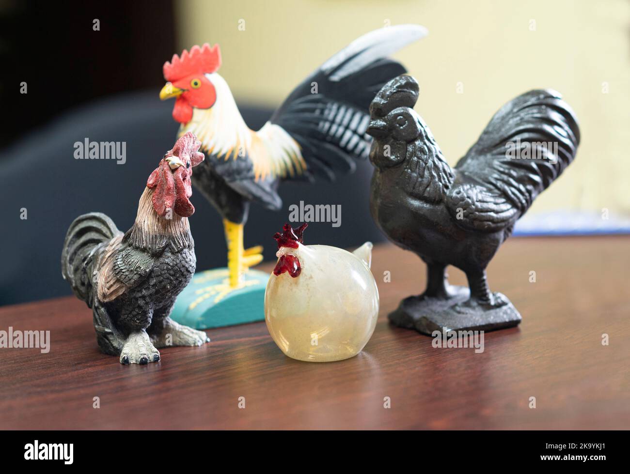 Collection of chicken figurines on top of a desk Stock Photo - Alamy