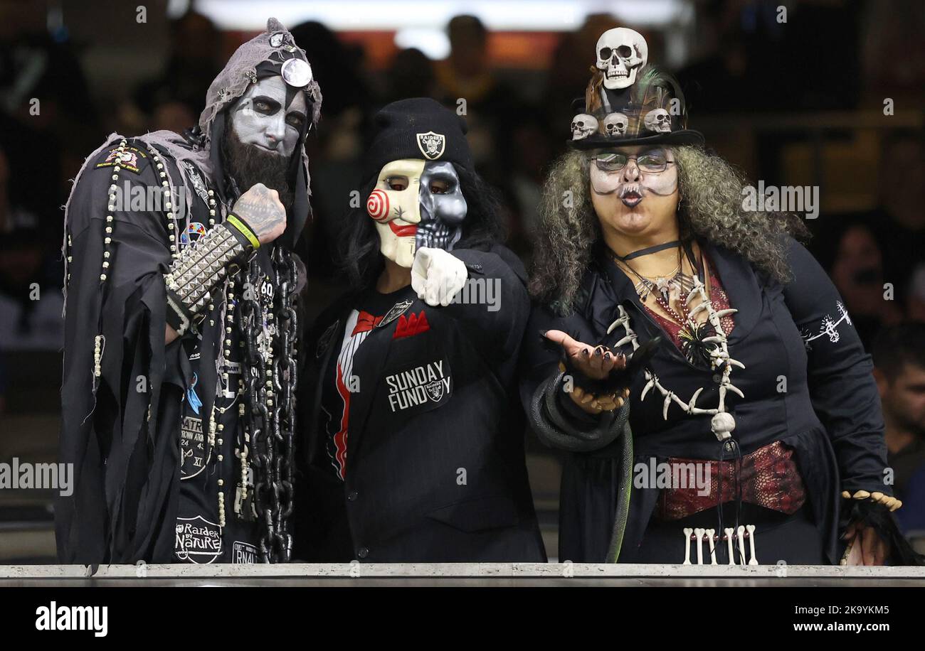 A trio of Las Vegas Raiders fans pose for a photo during a National ...