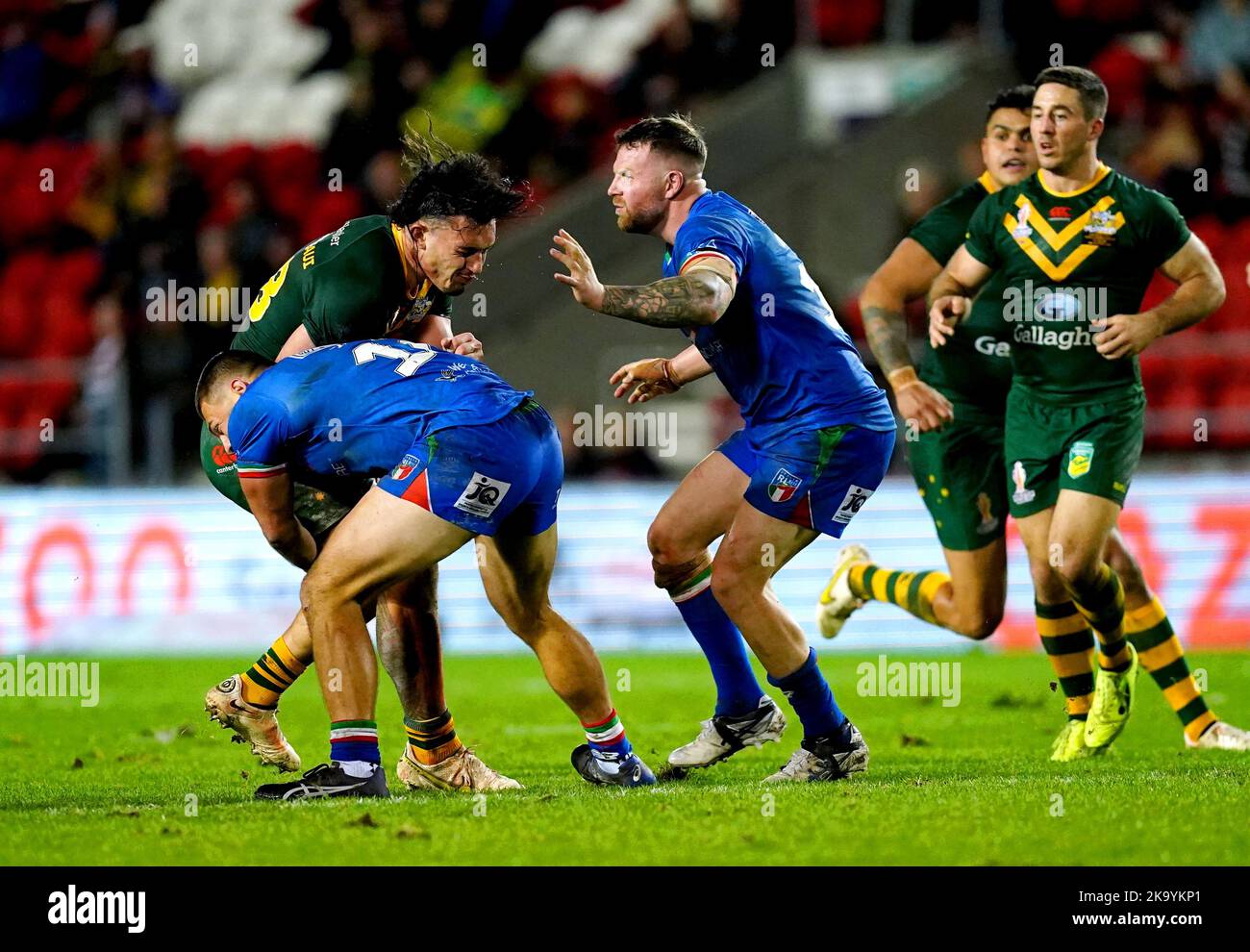 Australia's Tino Fa'asuamaleaui is tackled by Italy's Anton Iaria ...