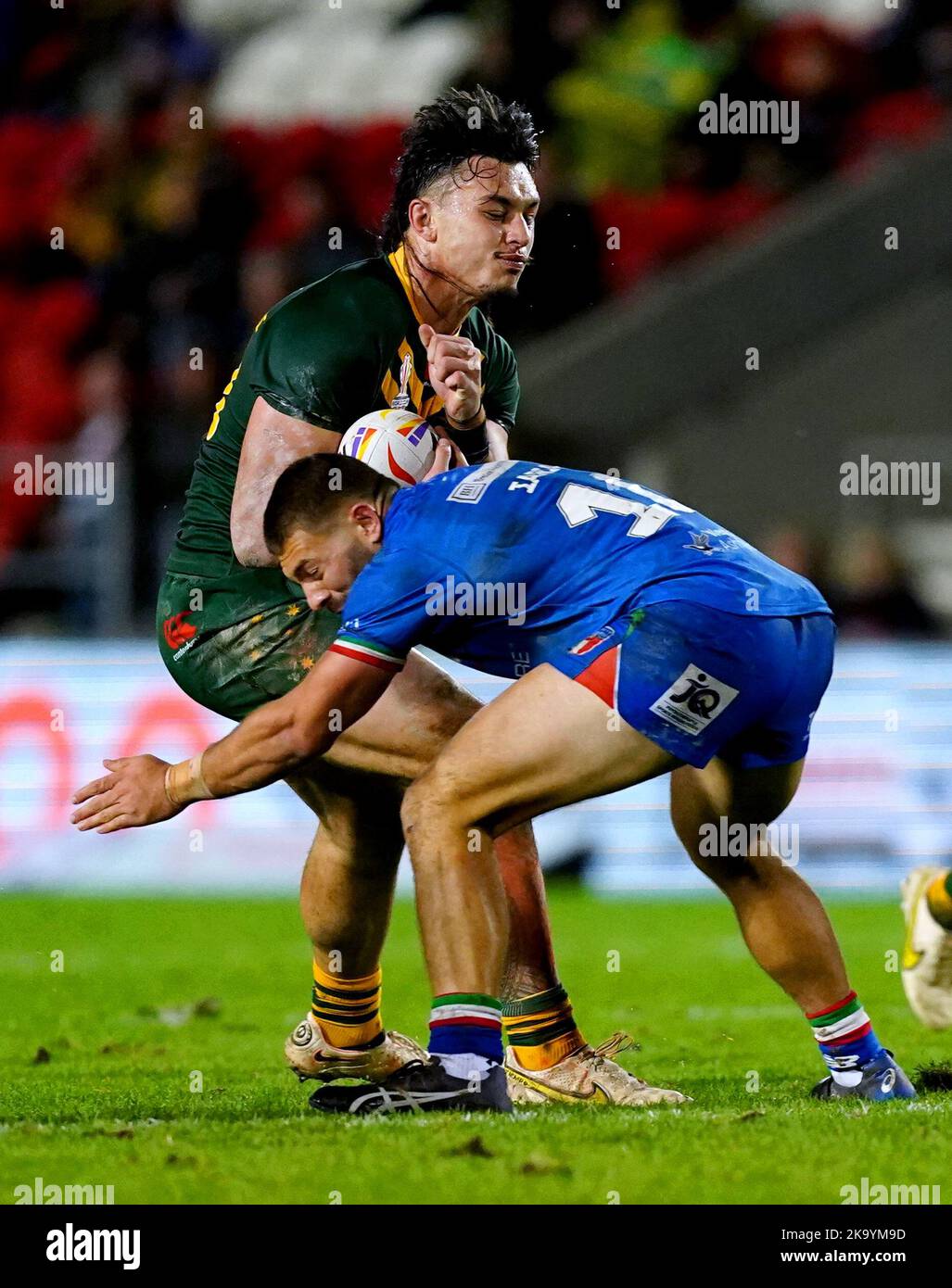 Australia's Tino Fa'asuamaleaui is tackled by Italy's Anton Iaria ...
