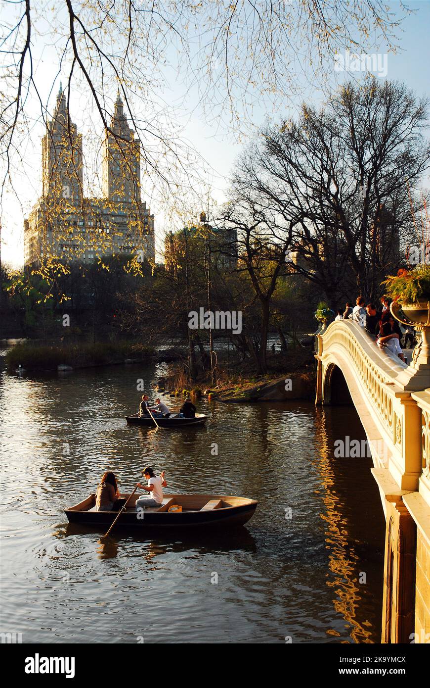 People enjoy a warm early spring day rowing in a rowboat on the lake in ...