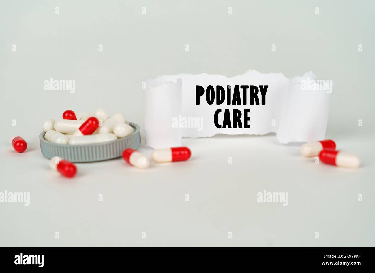 Medical concept. On a gray background, medical capsules and a paper ...