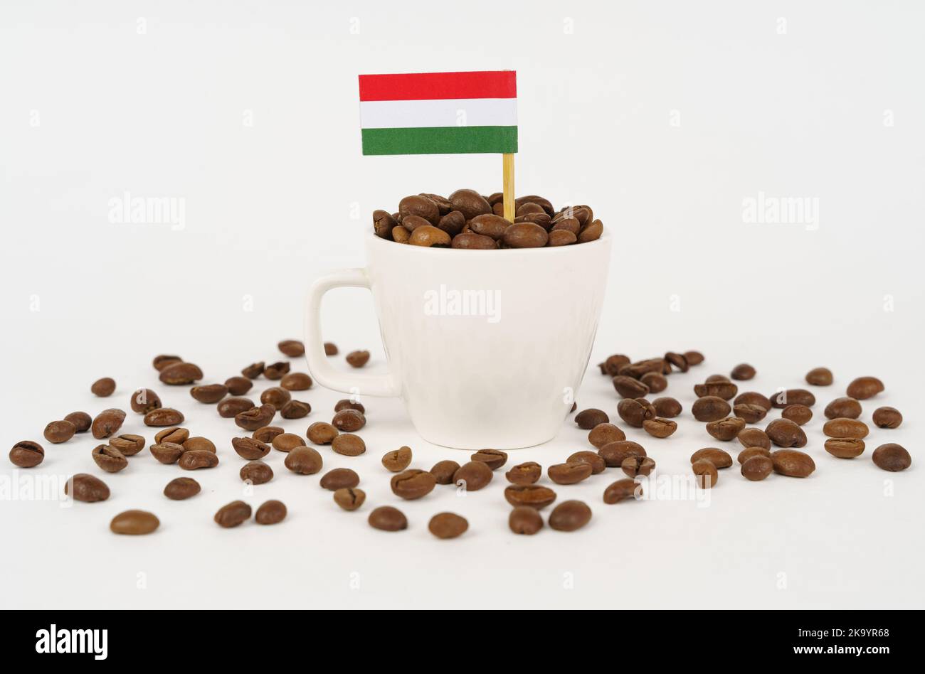 The flag of Hungary sticks out of a cup of roasted coffee beans ...