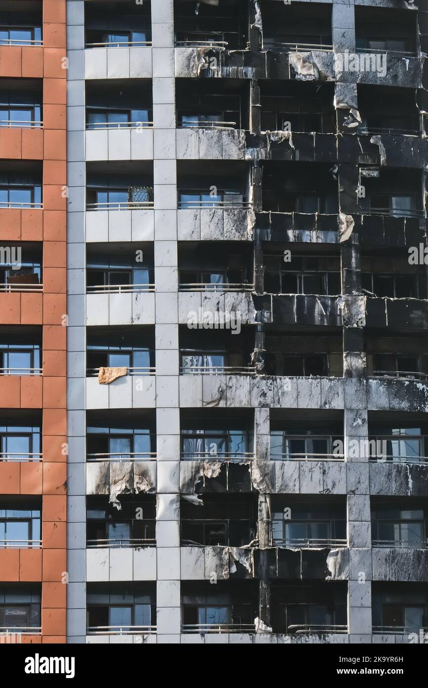 Ruined charred burnt residential high-rise building wall after fire ...