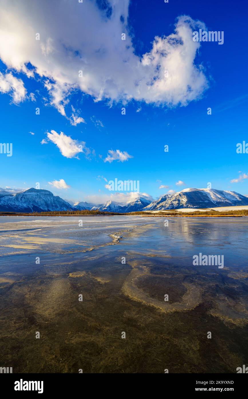The frozen surface of Maskinonge Lake in Waterton National Park ...