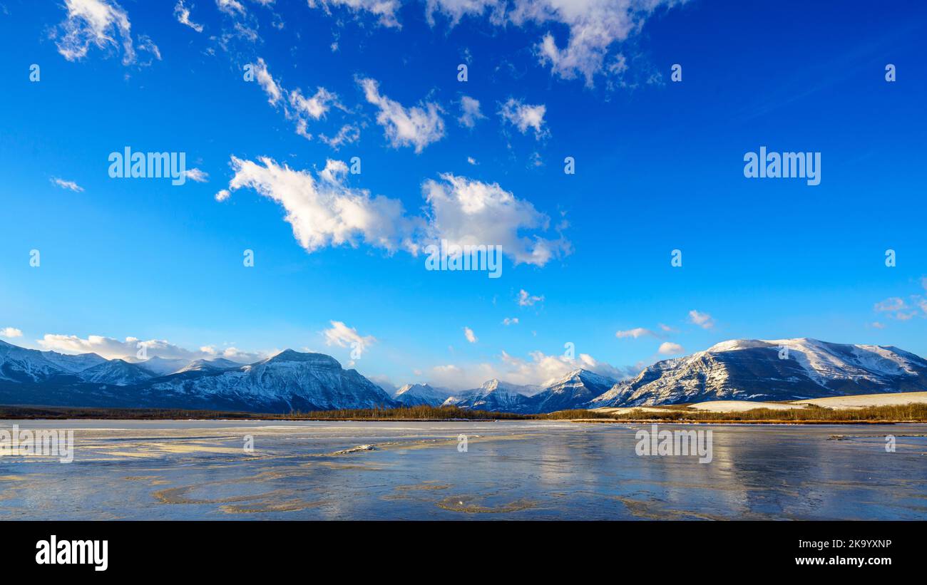 The frozen surface of Maskinonge Lake in Waterton National Park ...