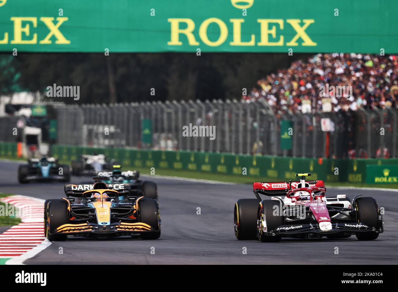 Daniel Ricciardo (AUS) McLaren MCL36 and Guanyu Zhou (CHN) Alfa Romeo ...