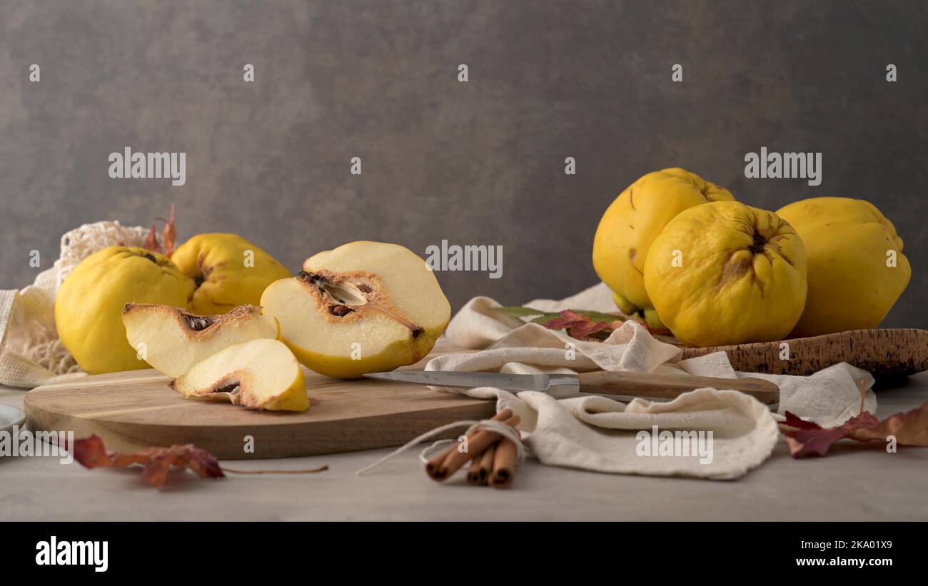 Ripe yellow quinces or queen apple fruits and sliced quince halves with ...
