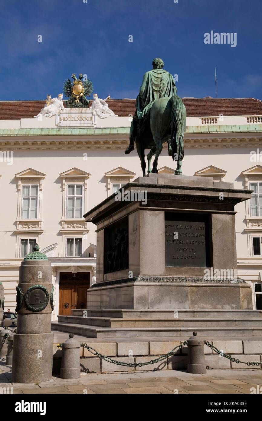Statue of Joseph II and old architectural style building at the Hofburg ...