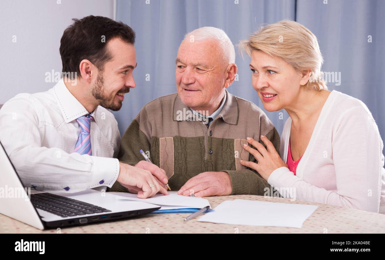 Woman and old man consider contract Stock Photo - Alamy