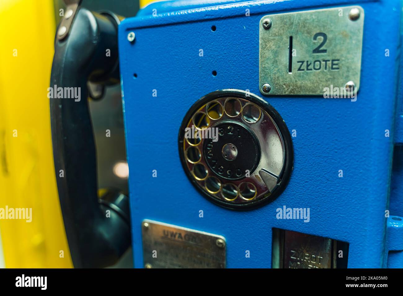 Old vintage Polish telephone in a booth. Dark blue metal telephone with ...