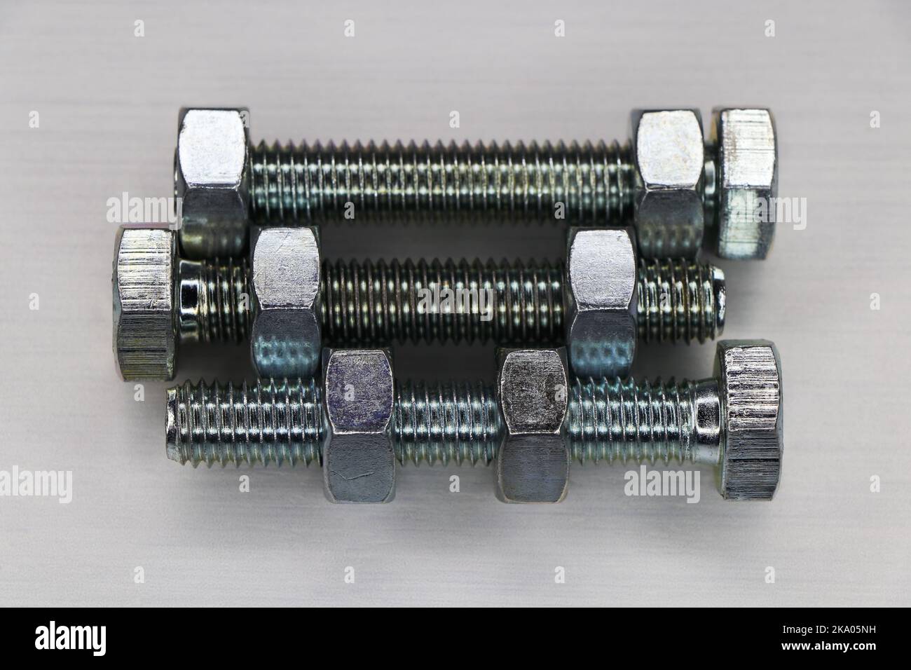 Three Threaded Metal Bolts With Hex Nuts Stock Photo - Alamy