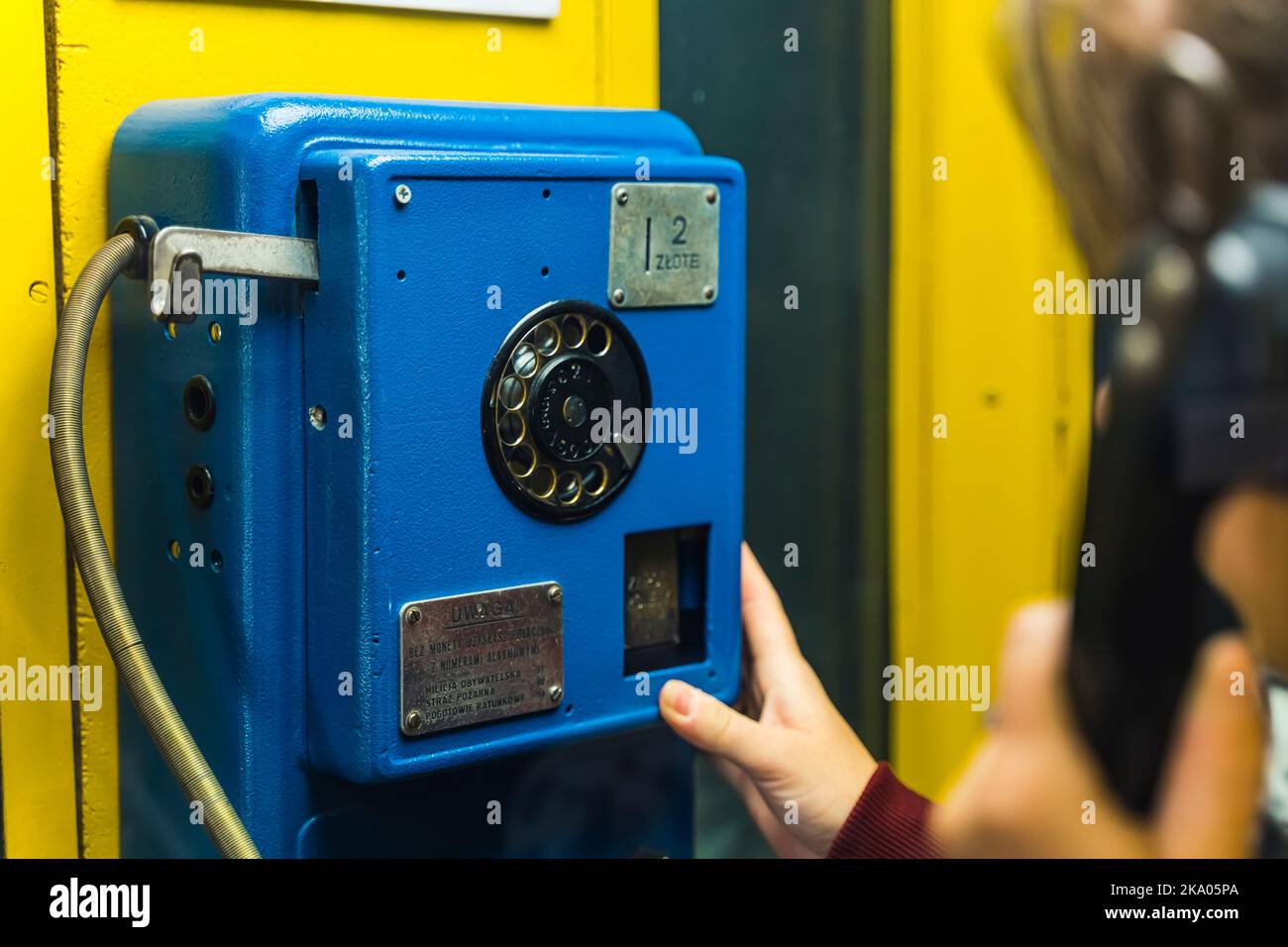 Blurred caucasian unrecognizable person holding black receiver in one ...