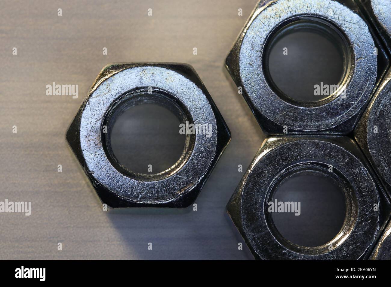 Metal Hex Nuts Close-up On Textured Surface Stock Photo - Alamy