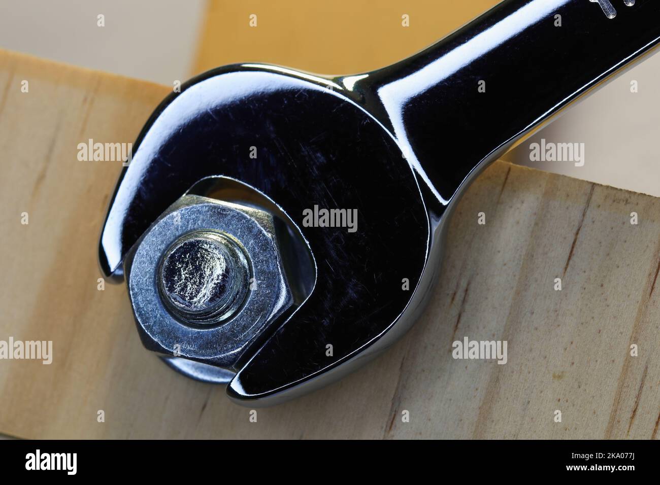 Spanner Tightening Hex Nut To Bolt On Wood Stock Photo - Alamy