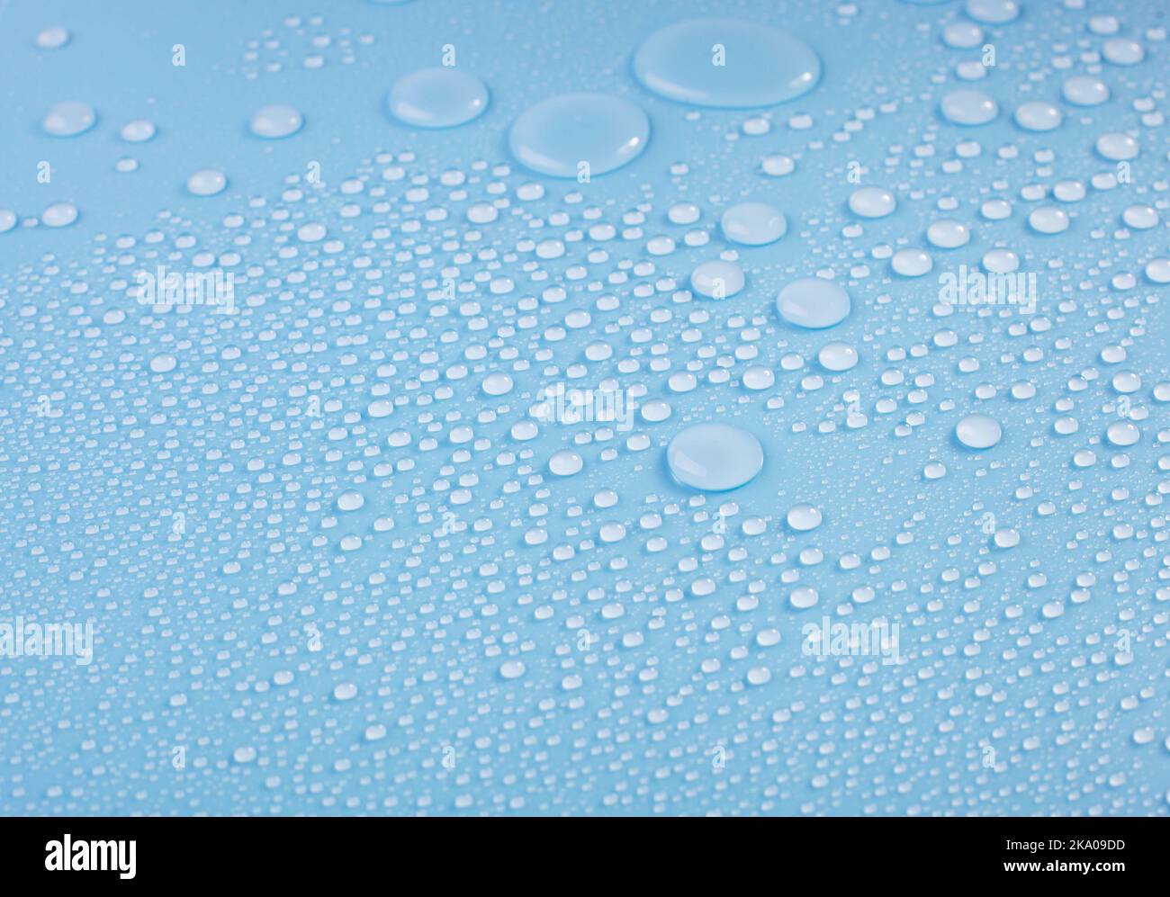 Waterdrop formation on blue background Stock Photo - Alamy