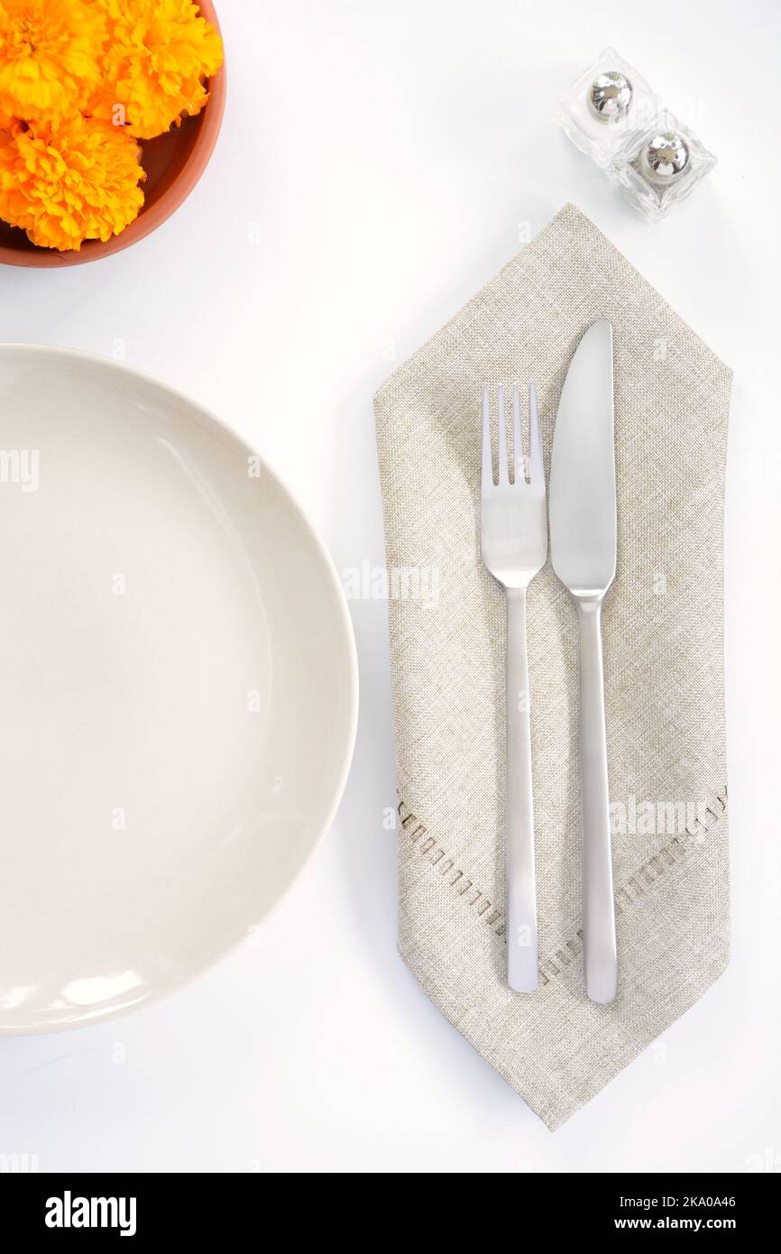 Neutral place setting with modern stainless steel cutlery and vibrant ...