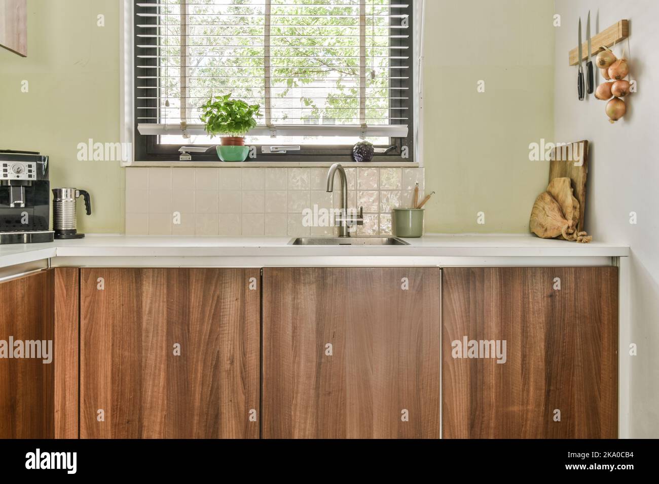 Table with chairs and flowers located near lounge area and kitchen in ...