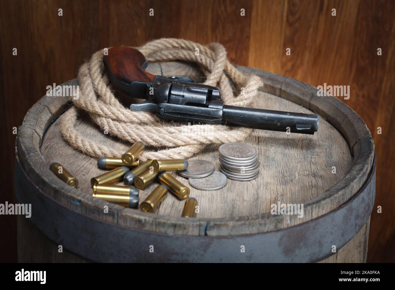 Old west revolver with cartridges on wooden barrel Stock Photo - Alamy