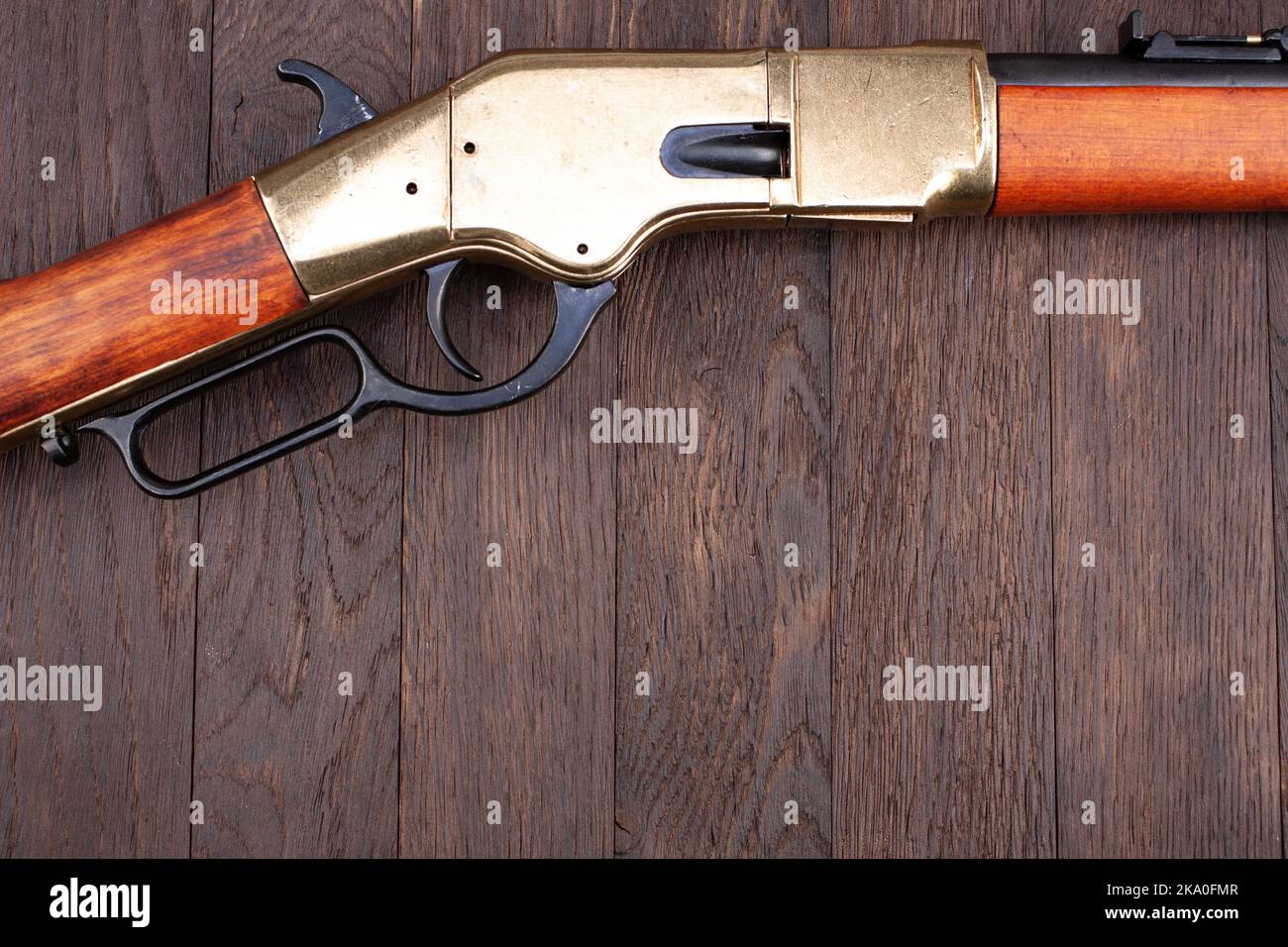 Old west gun. Lever-action repeating rifle on wooden table Stock Photo ...