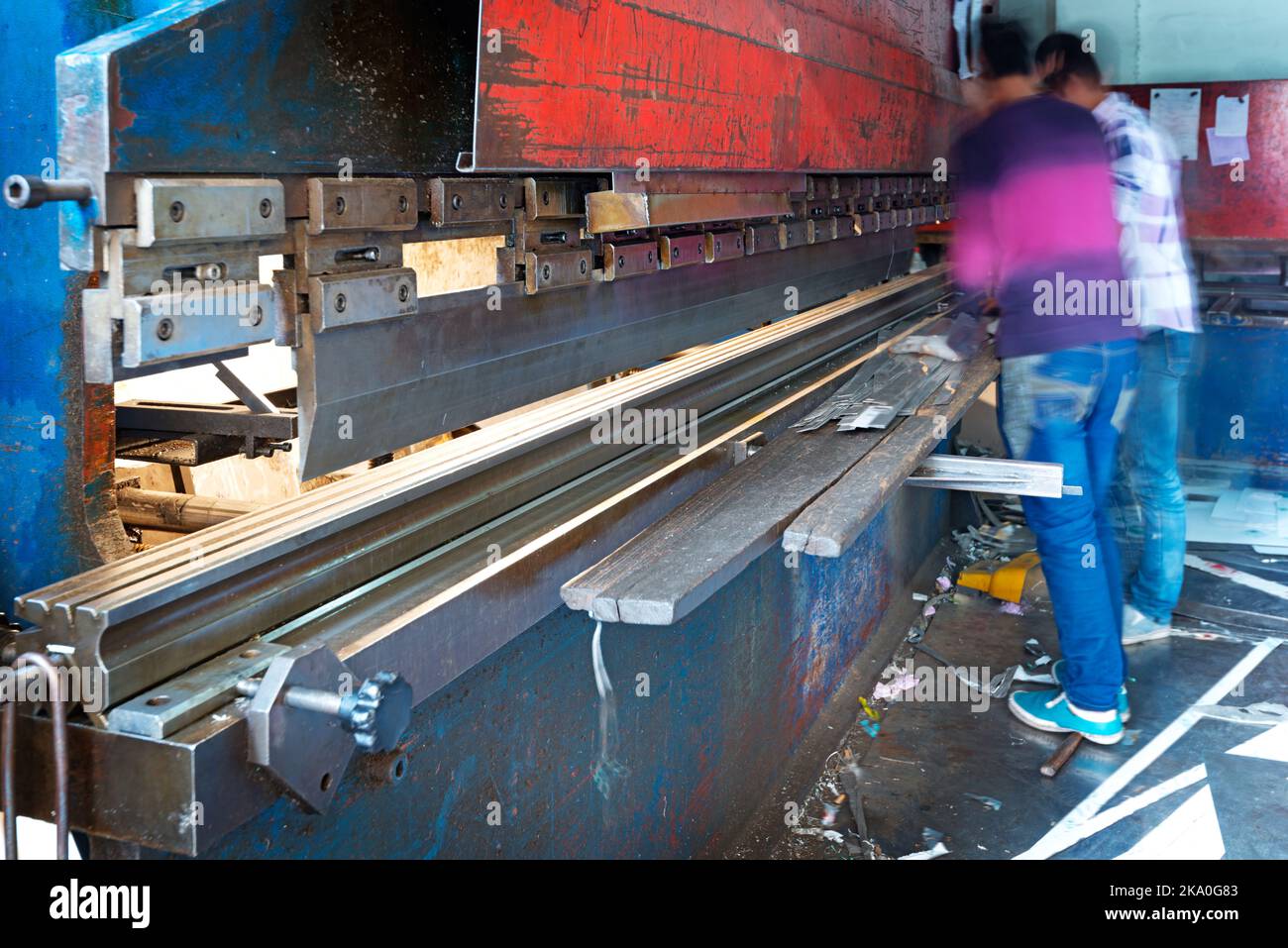 Sheet of metal and hands of worker who works on press Stock Photo - Alamy
